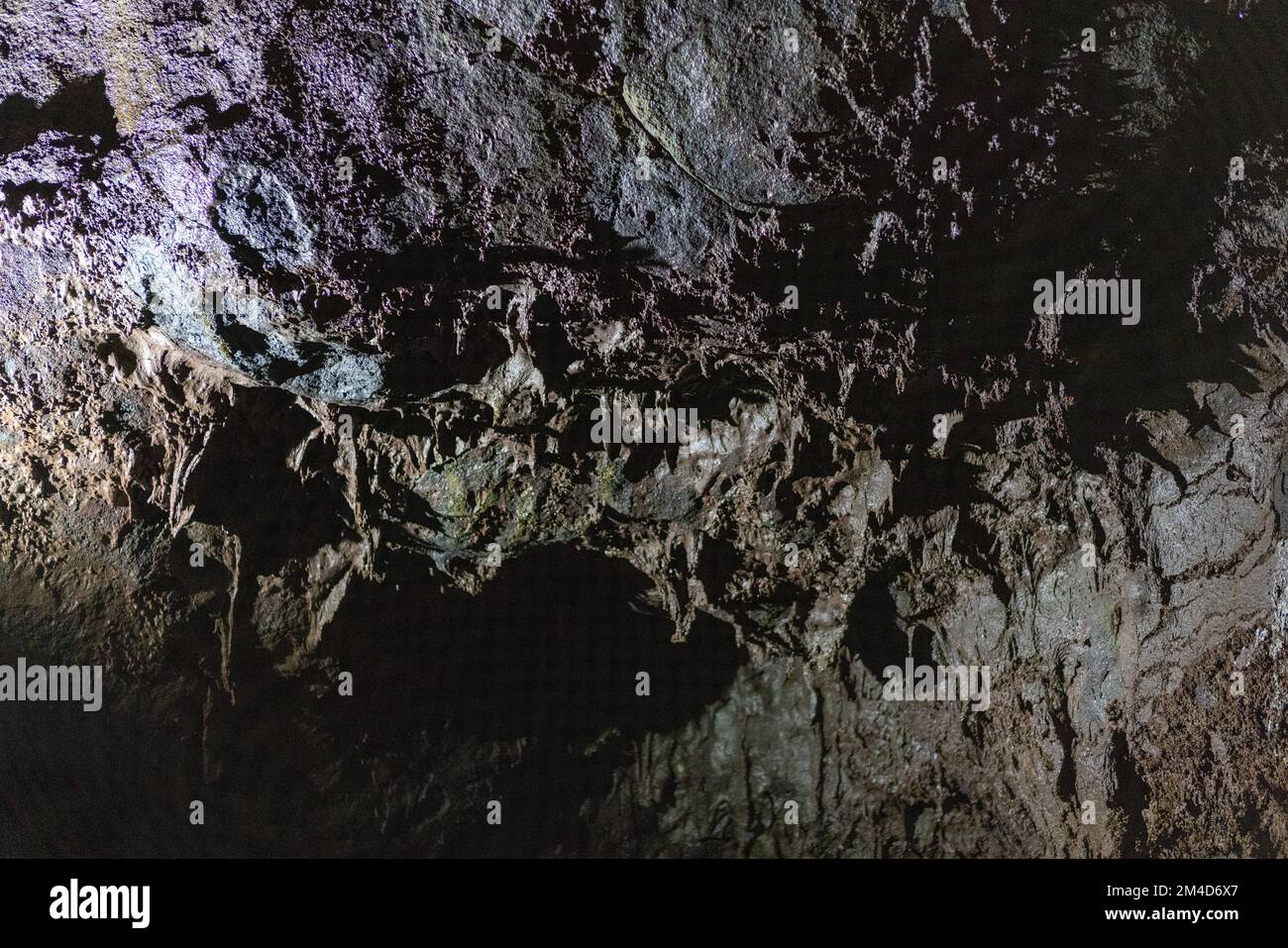 Exploring a volcanic cave in the Volcanic Caves Park at the foot of ...