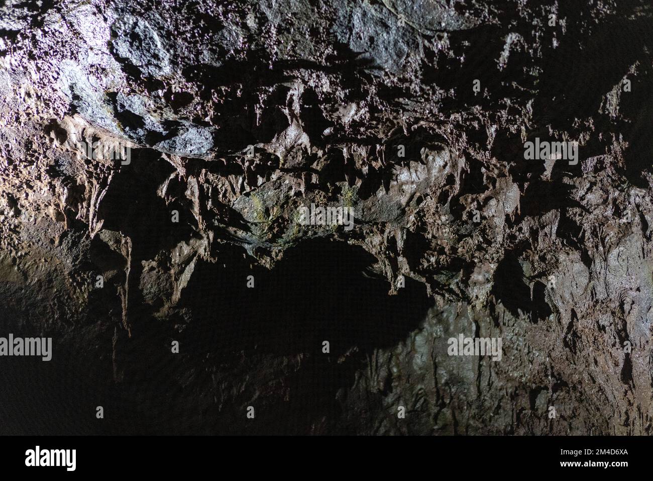 Exploring a volcanic cave in the Volcanic Caves Park at the foot of ...