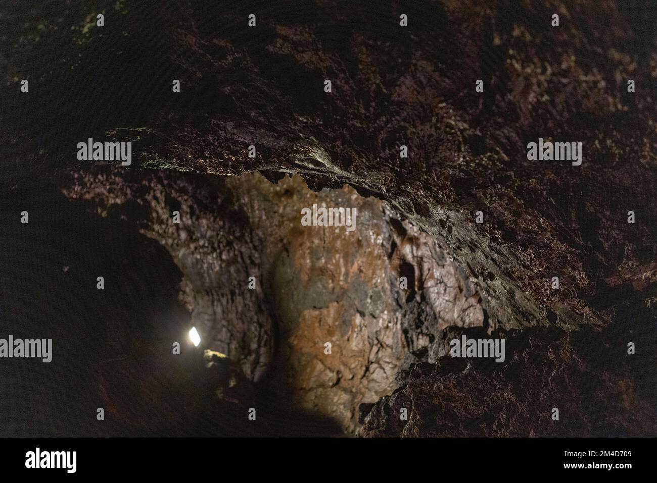 Exploring a volcanic cave in the Volcanic Caves Park at the foot of ...