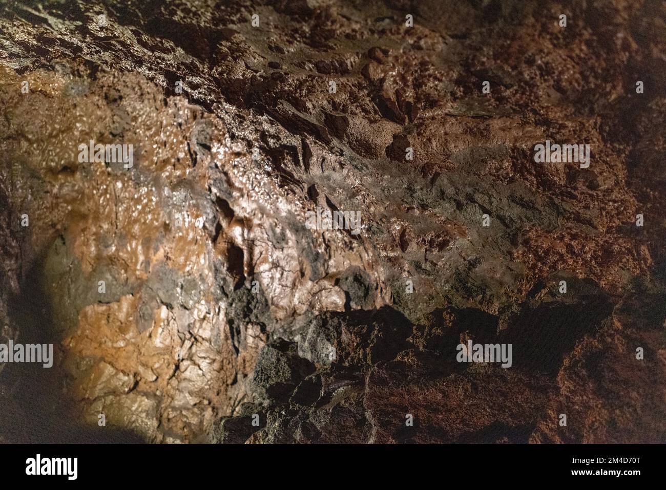 Exploring a volcanic cave in the Volcanic Caves Park at the foot of ...