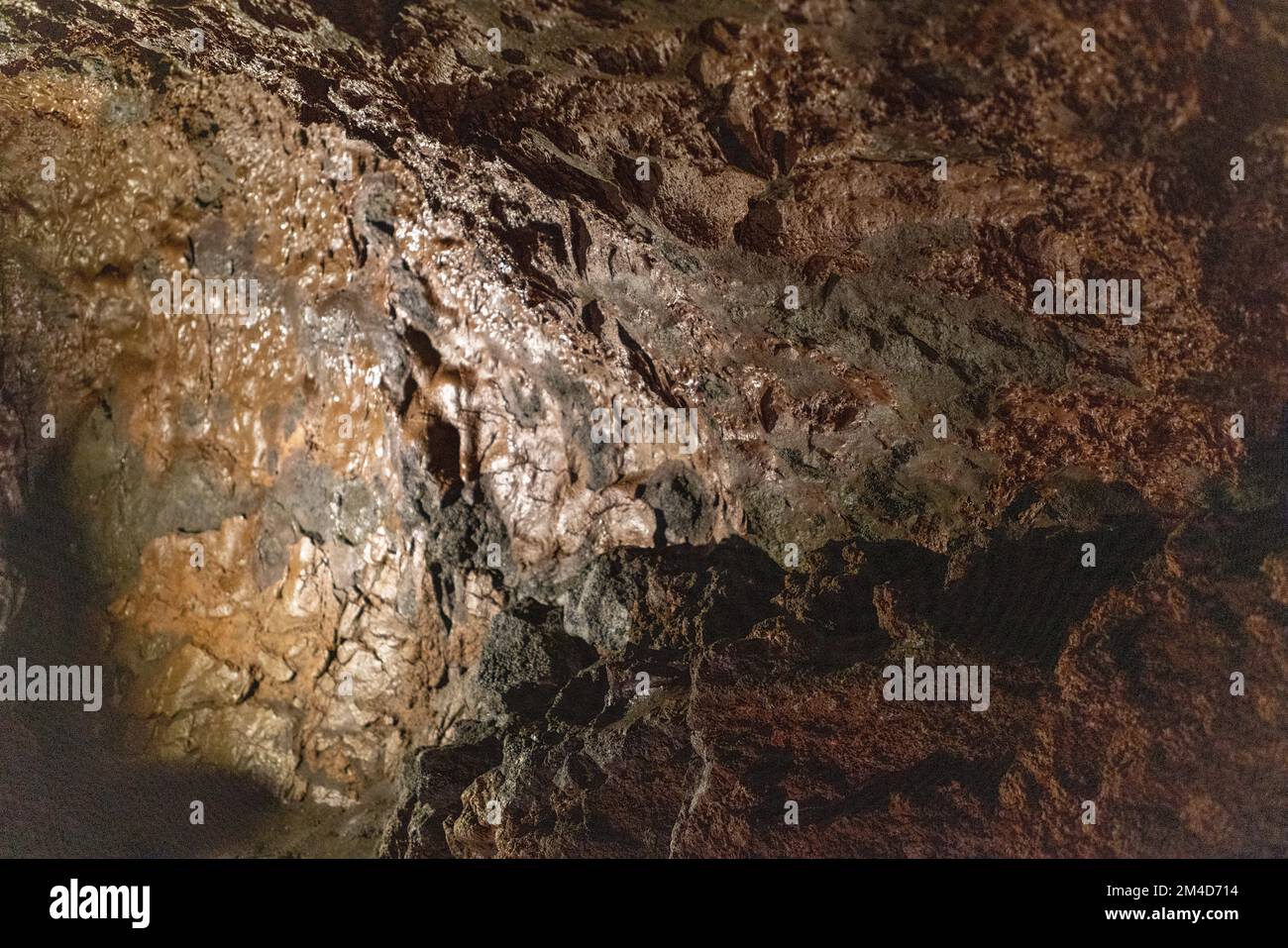 Exploring a volcanic cave in the Volcanic Caves Park at the foot of ...