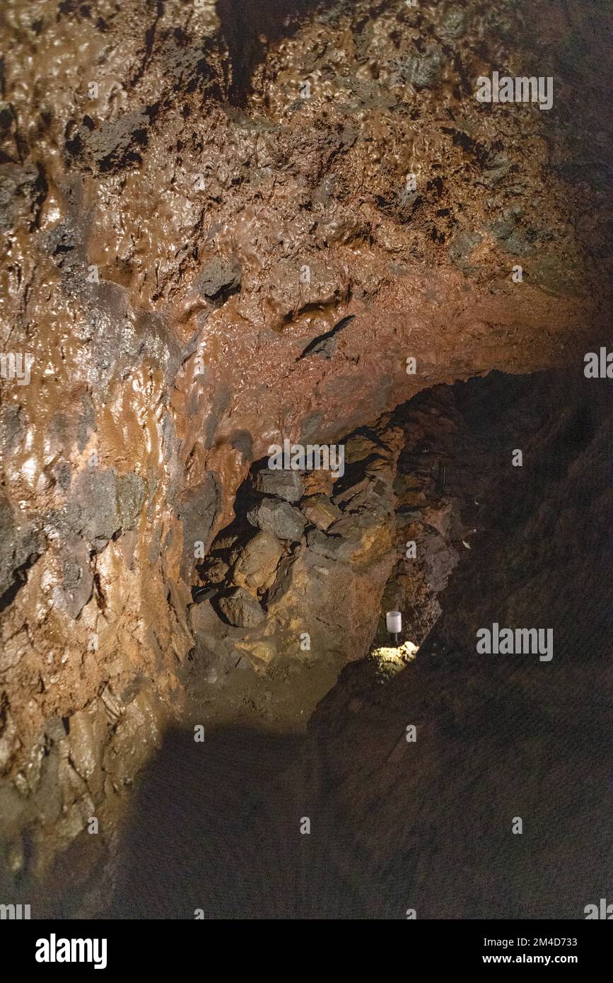 Exploring a volcanic cave in the Volcanic Caves Park at the foot of ...