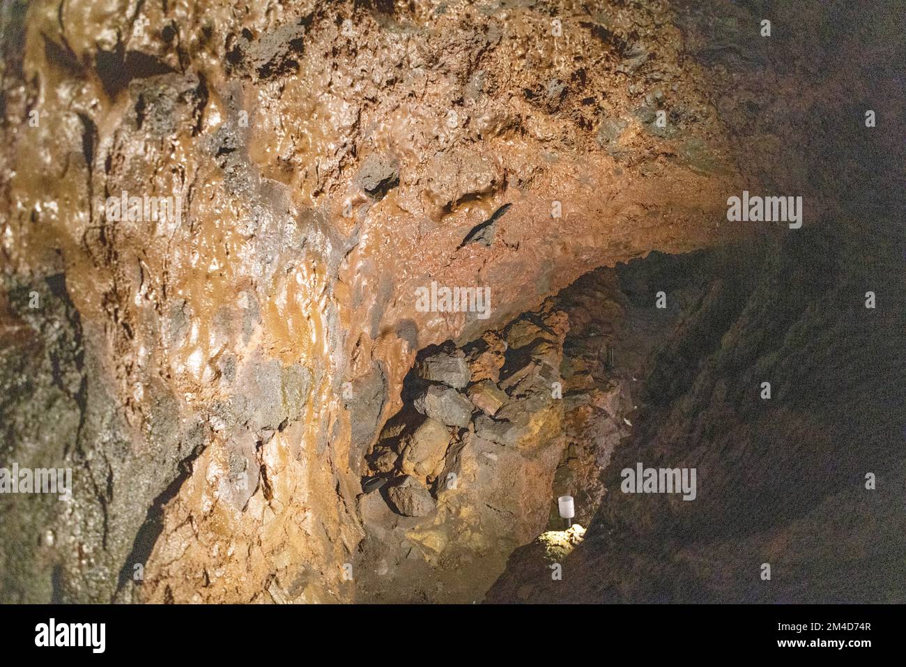 Exploring a volcanic cave in the Volcanic Caves Park at the foot of ...
