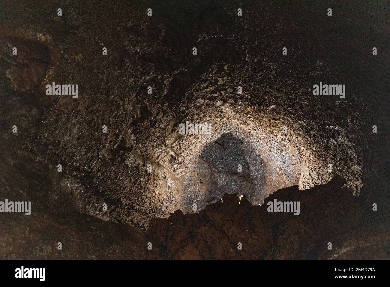 Exploring a volcanic cave in the Volcanic Caves Park at the foot of ...