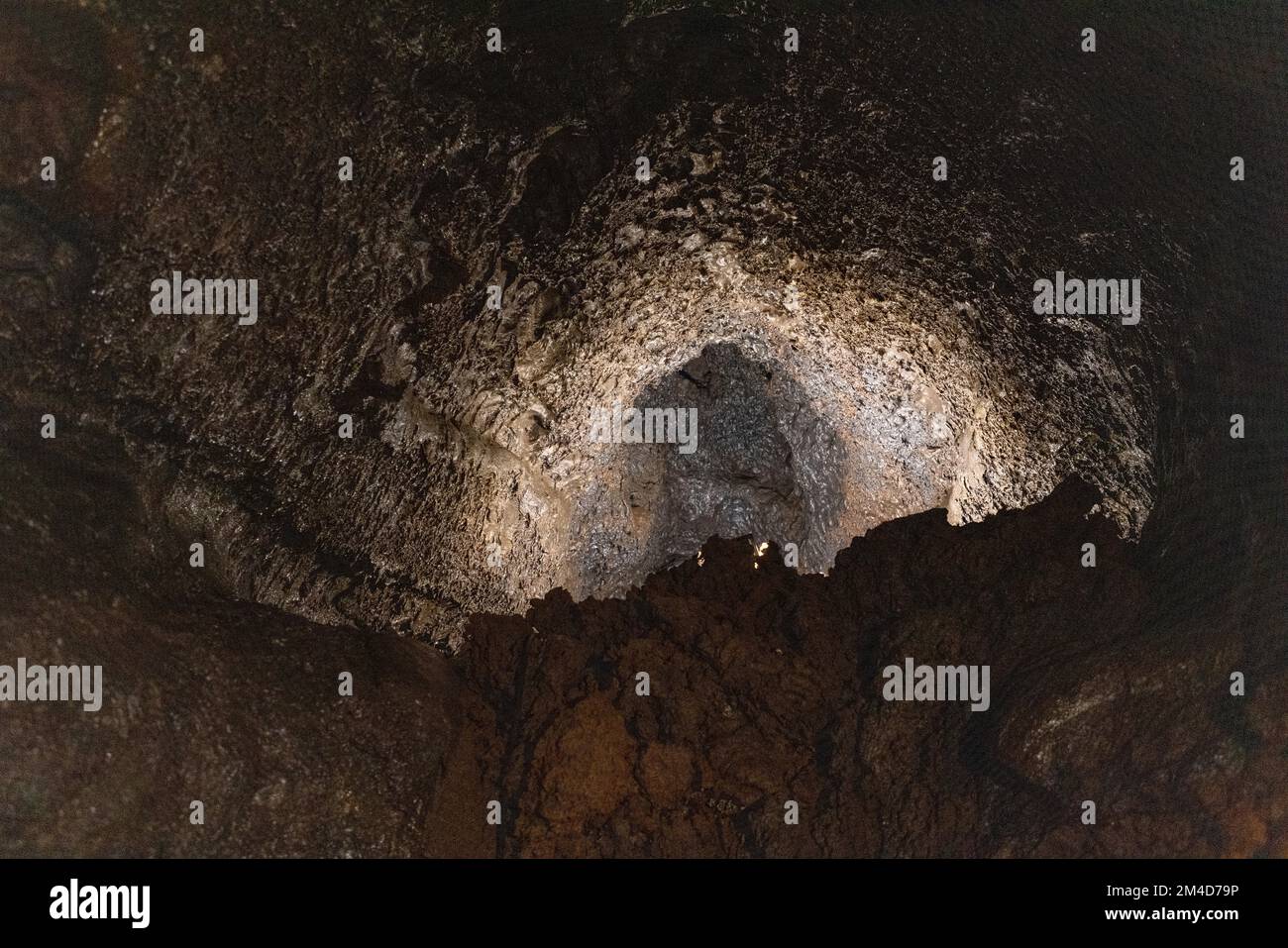 Exploring a volcanic cave in the Volcanic Caves Park at the foot of ...