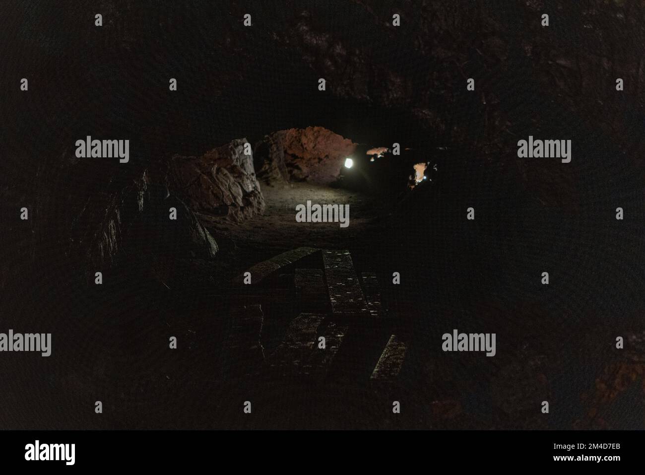 Exploring a volcanic cave in the Volcanic Caves Park at the foot of ...