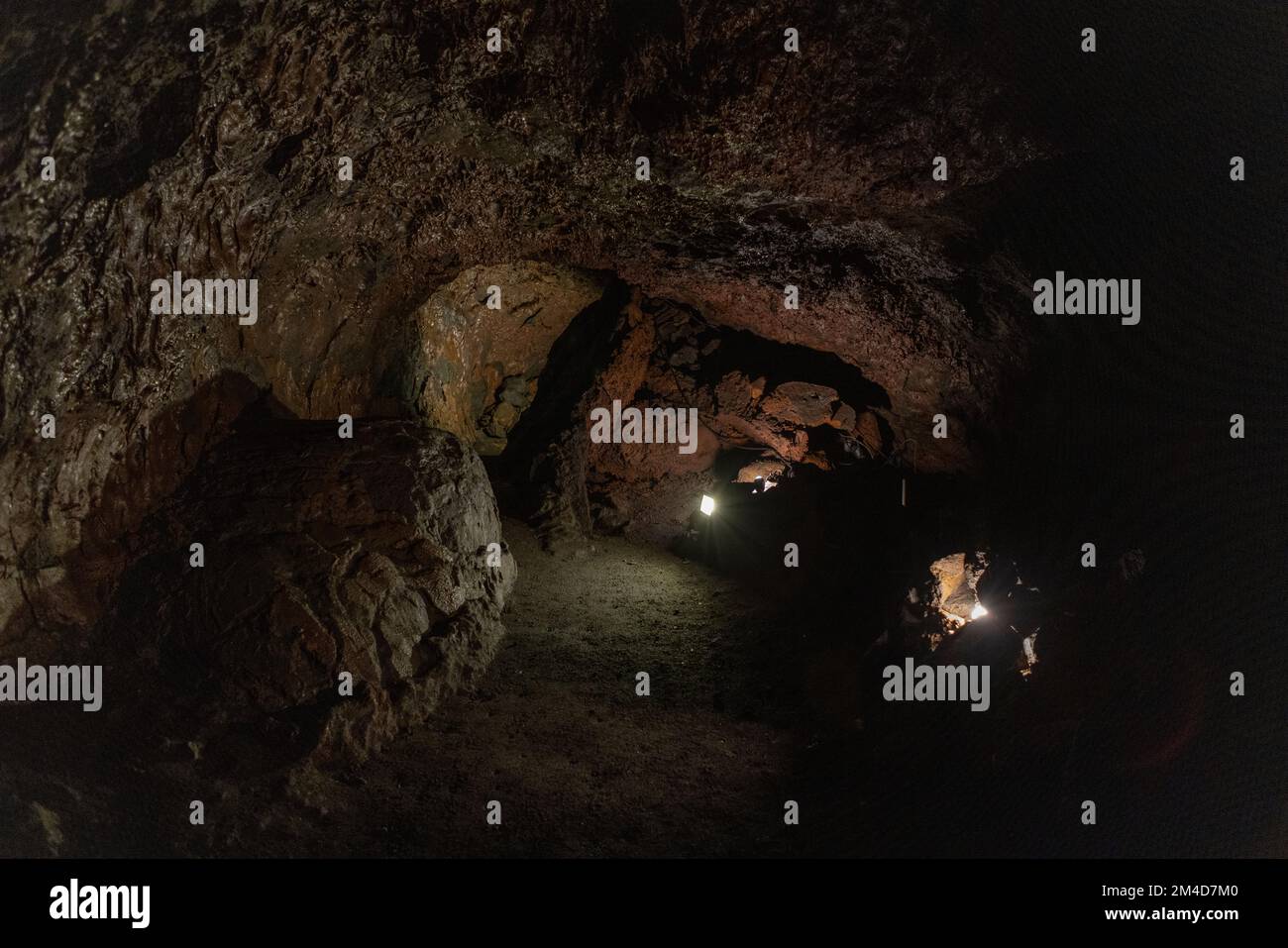 Exploring a volcanic cave in the Volcanic Caves Park at the foot of ...