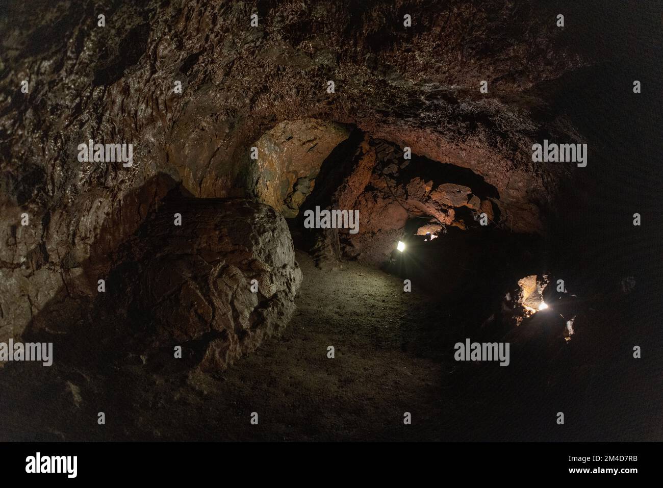 Exploring a volcanic cave in the Volcanic Caves Park at the foot of ...
