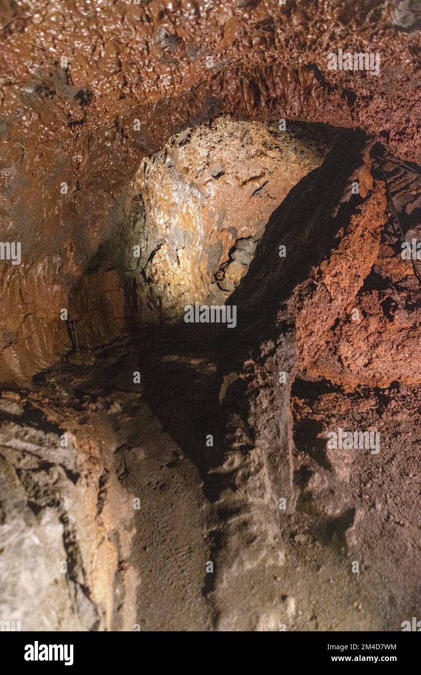 Exploring a volcanic cave in the Volcanic Caves Park at the foot of ...