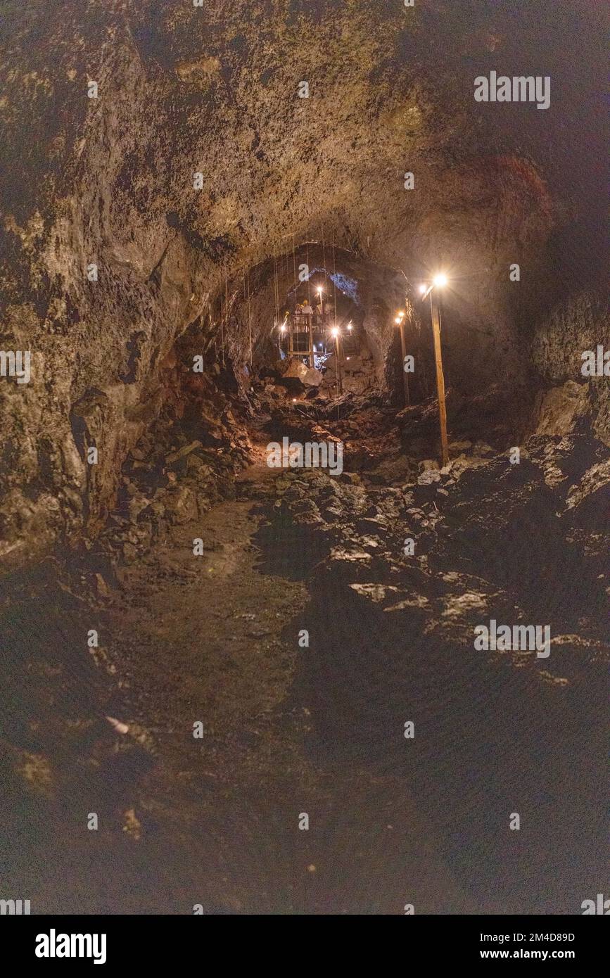 Exploring a volcanic cave in the Volcanic Caves Park at the foot of ...
