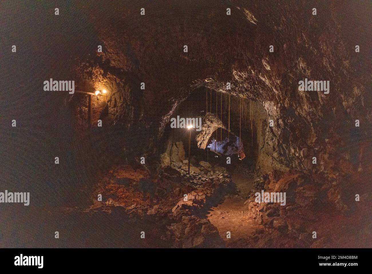 Exploring a volcanic cave in the Volcanic Caves Park at the foot of ...