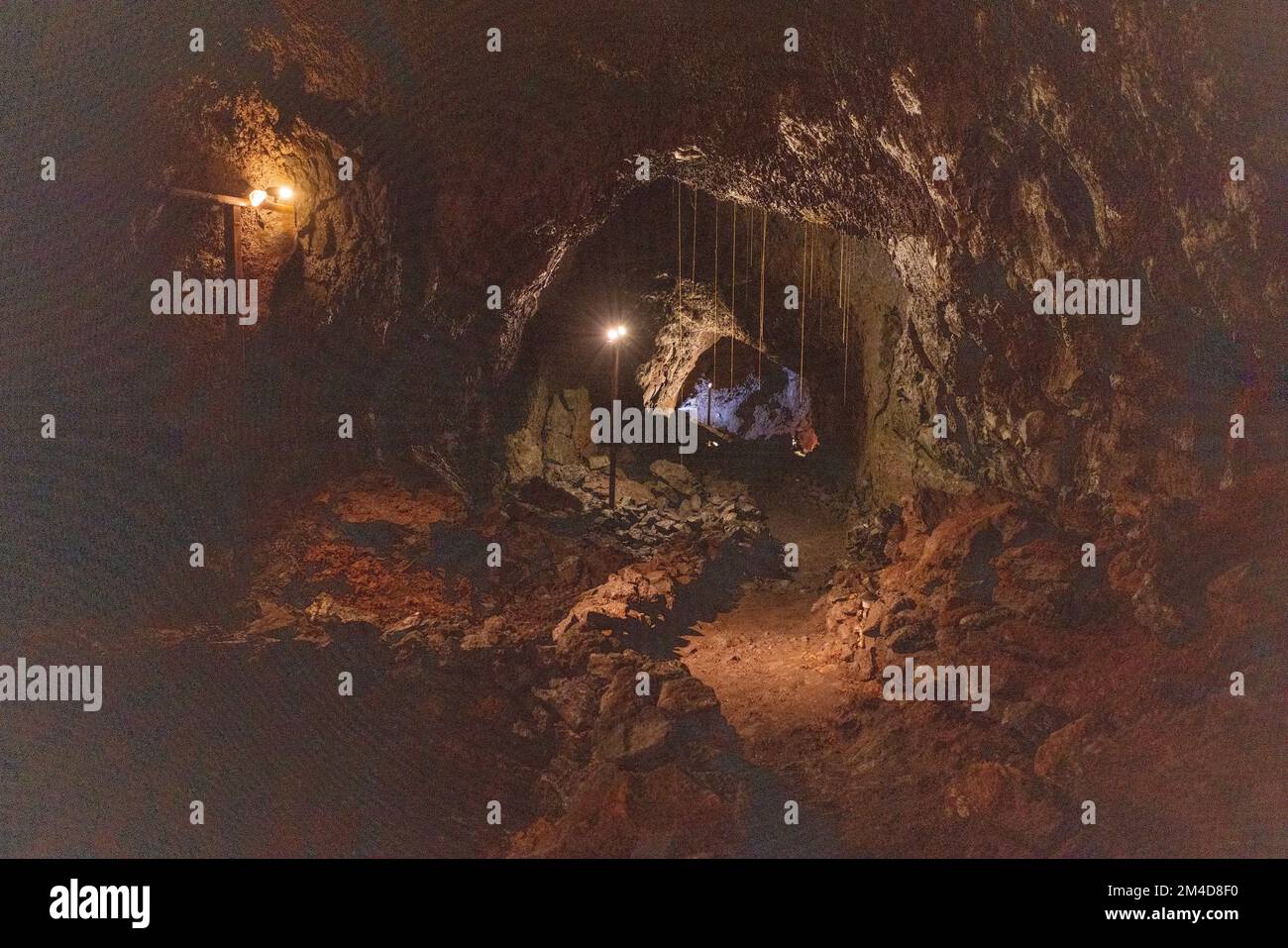 Exploring a volcanic cave in the Volcanic Caves Park at the foot of ...