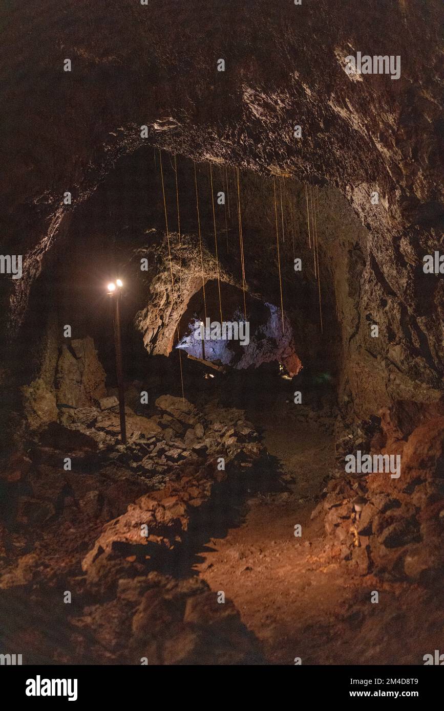 Exploring a volcanic cave in the Volcanic Caves Park at the foot of ...