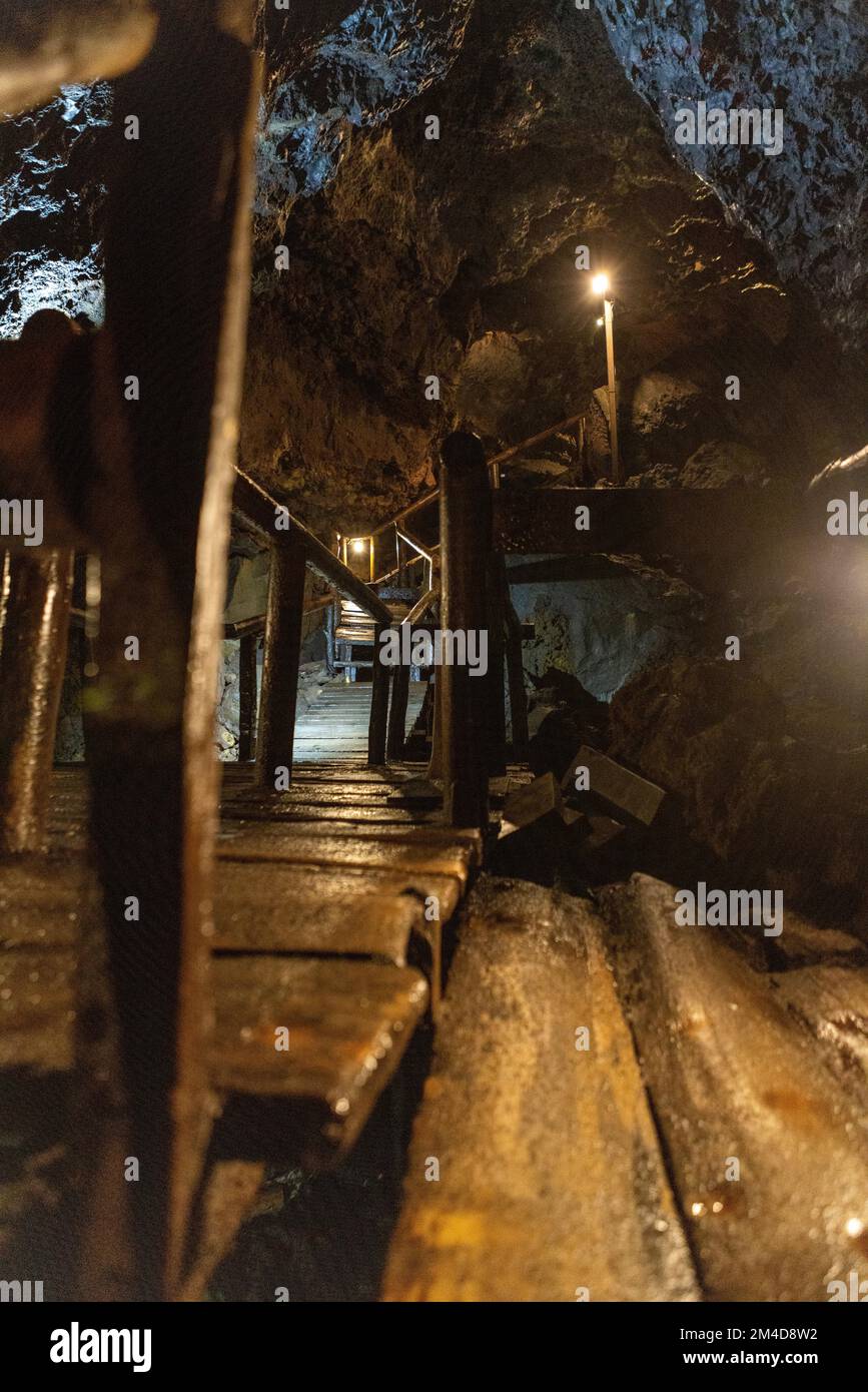 Exploring a volcanic cave in the Volcanic Caves Park at the foot of ...