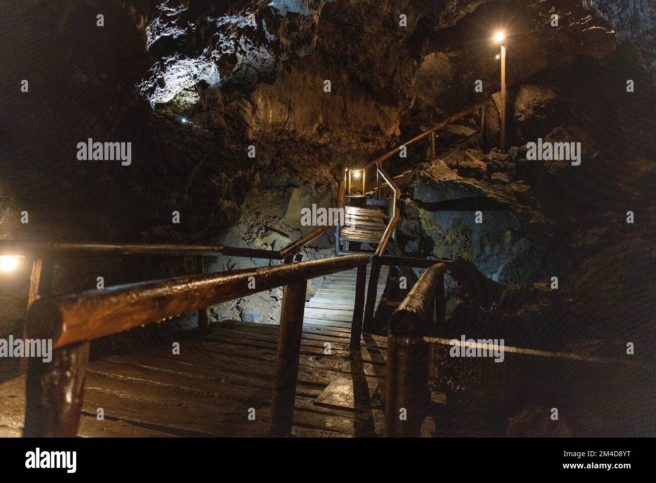 Exploring a volcanic cave in the Volcanic Caves Park at the foot of ...