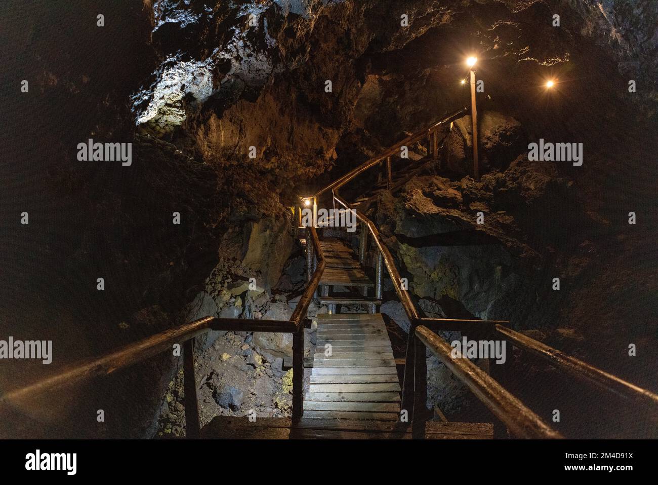 Exploring a volcanic cave in the Volcanic Caves Park at the foot of ...