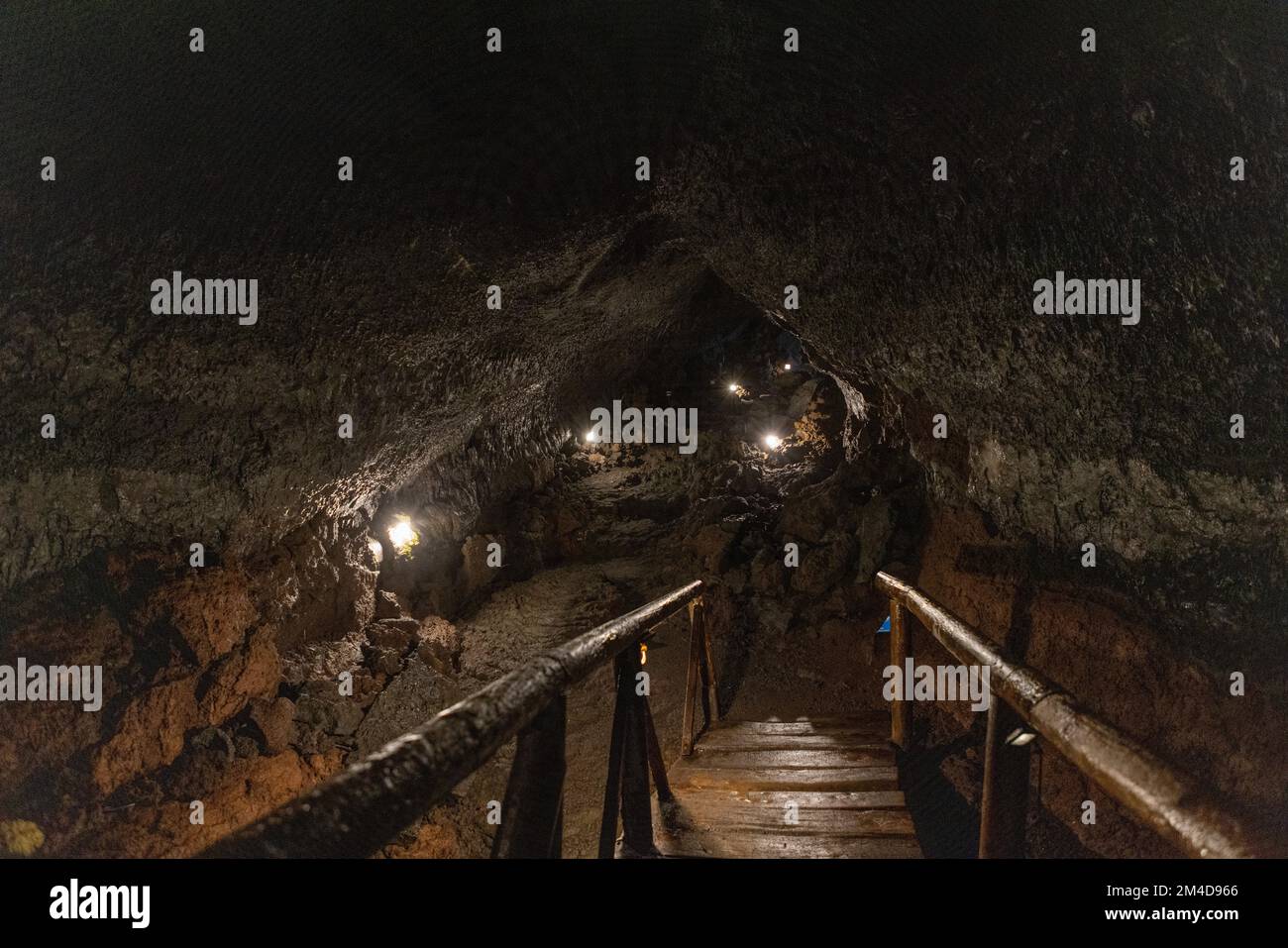 Exploring a volcanic cave in the Volcanic Caves Park at the foot of ...