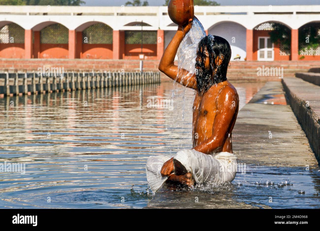 Holy man taking bath in the tank of Kurukshetra, the place of the ...