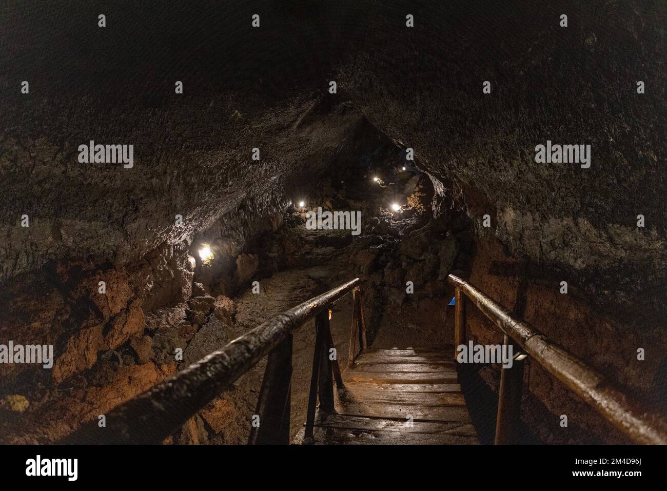 Exploring a volcanic cave in the Volcanic Caves Park at the foot of ...