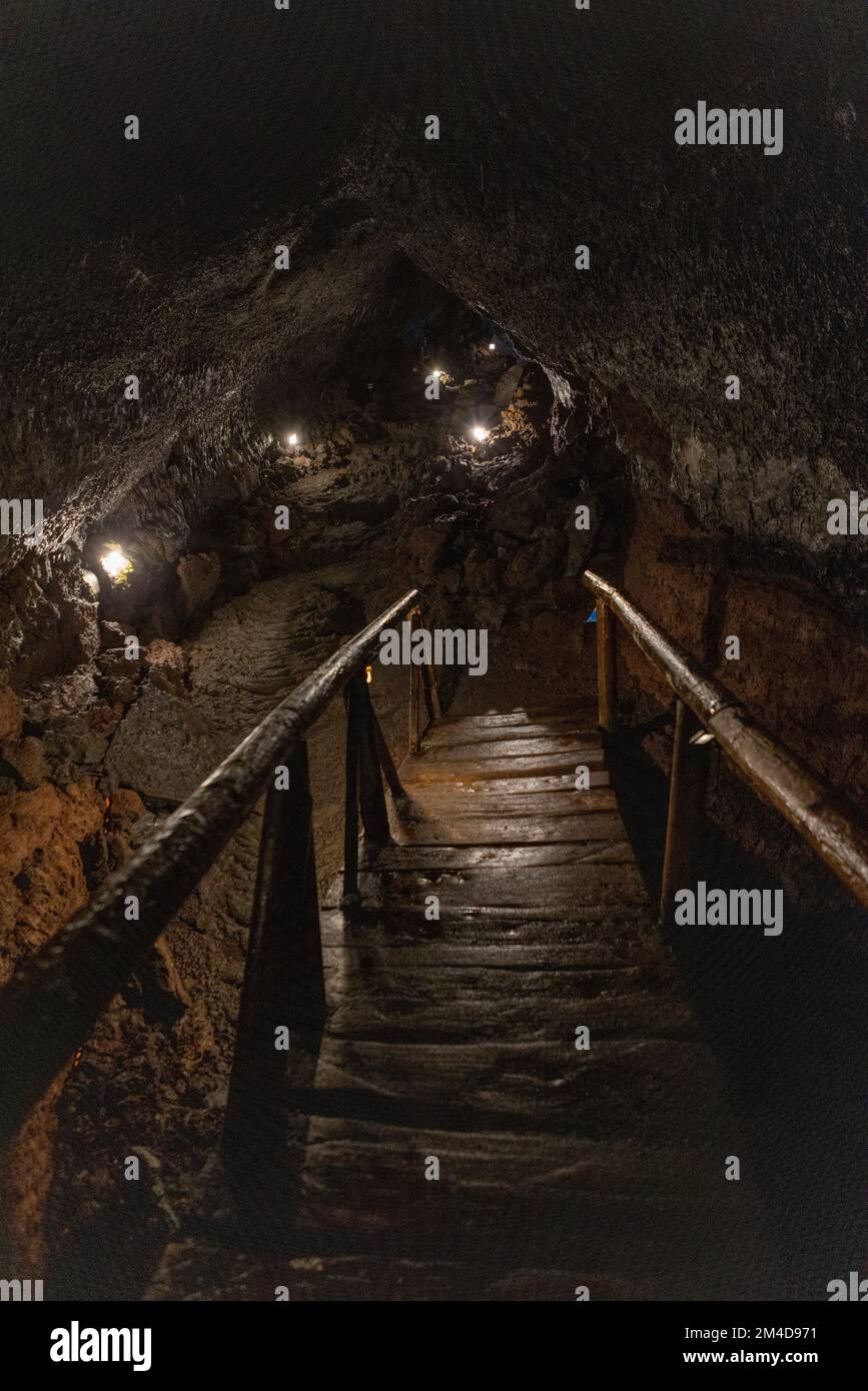 Exploring a volcanic cave in the Volcanic Caves Park at the foot of ...