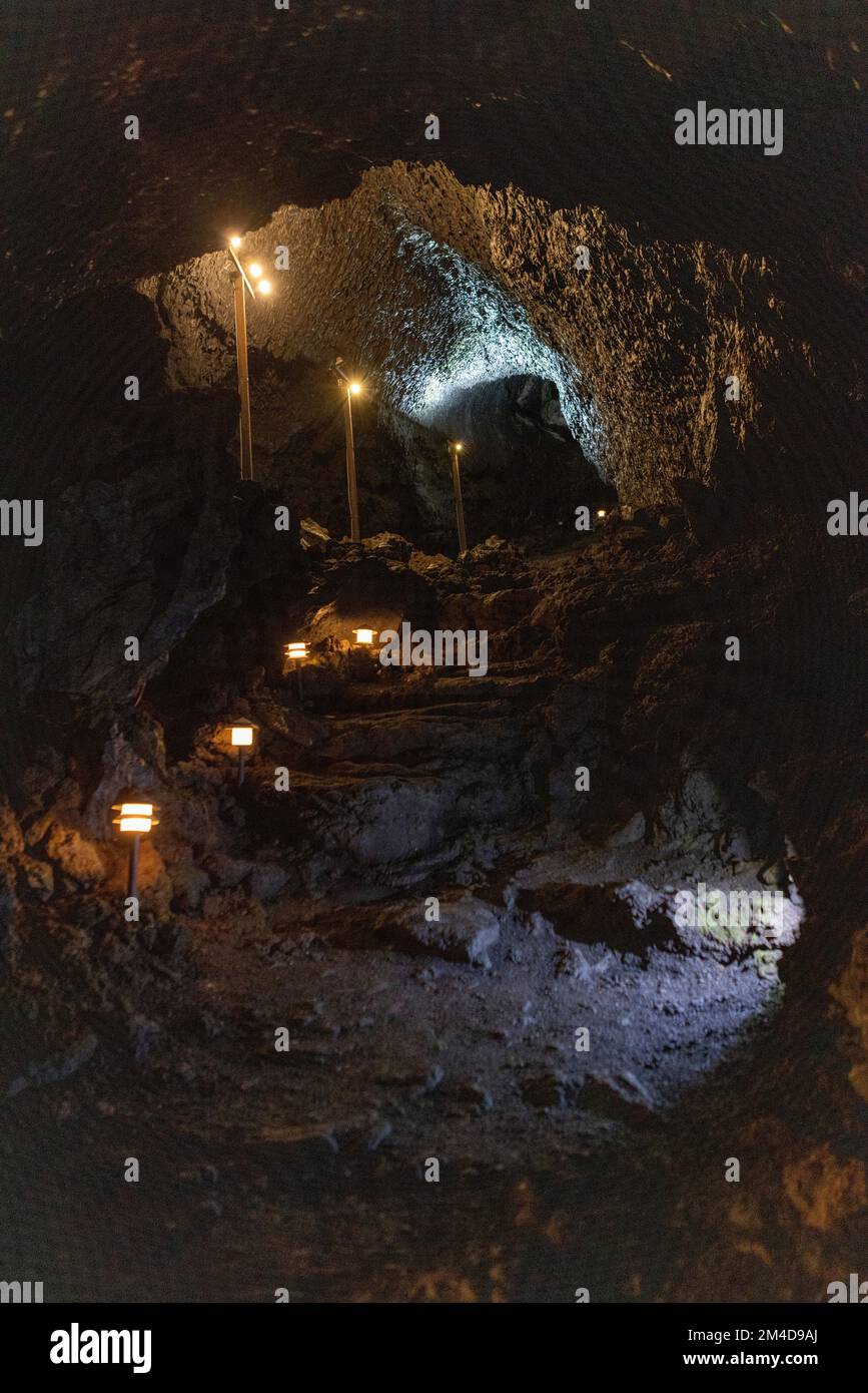 Exploring a volcanic cave in the Volcanic Caves Park at the foot of ...