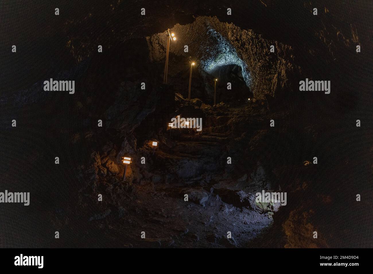 Exploring a volcanic cave in the Volcanic Caves Park at the foot of ...