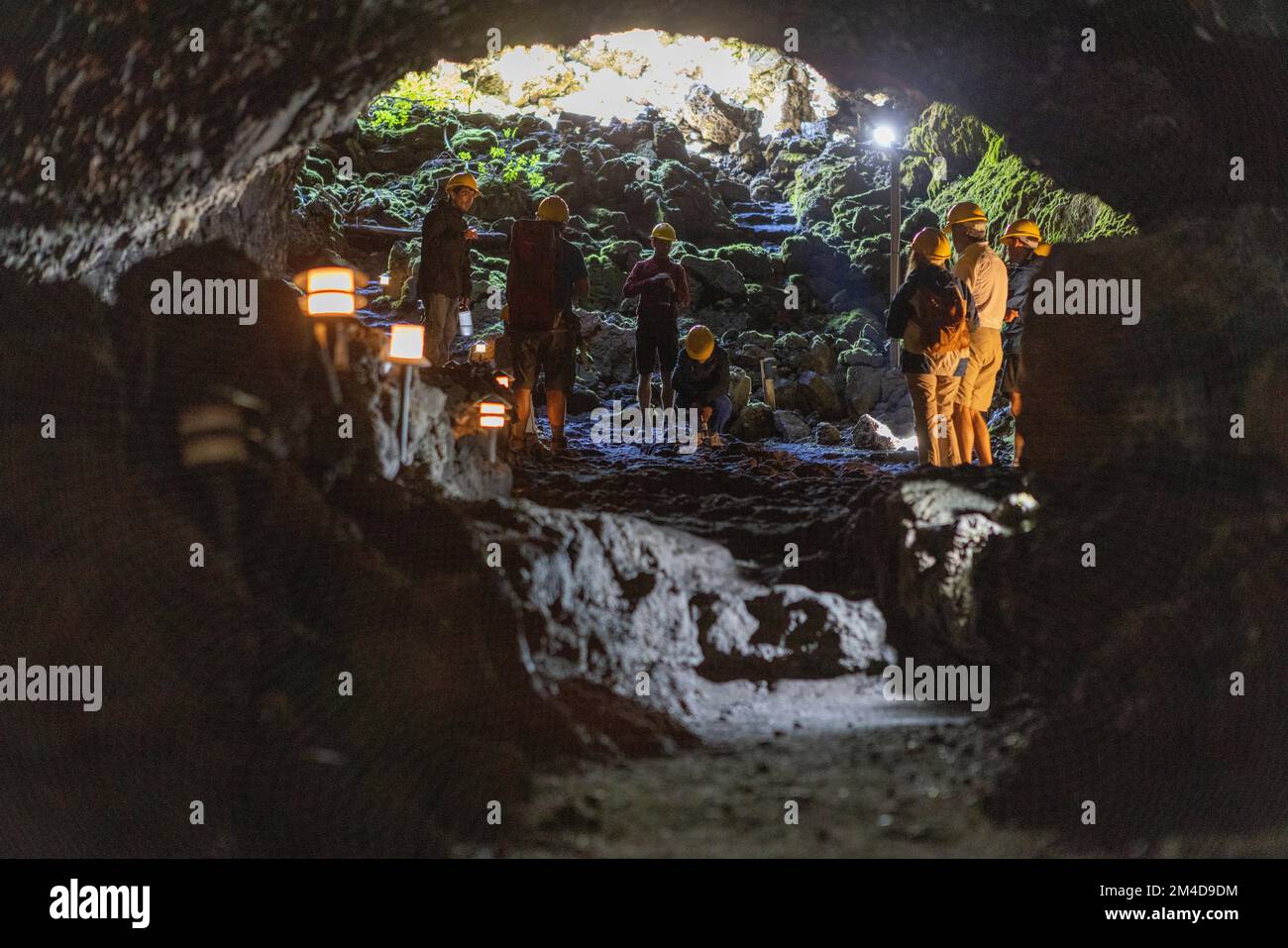 Group exploring a volcanic cave in the Volcanic Caves Park at the foot ...