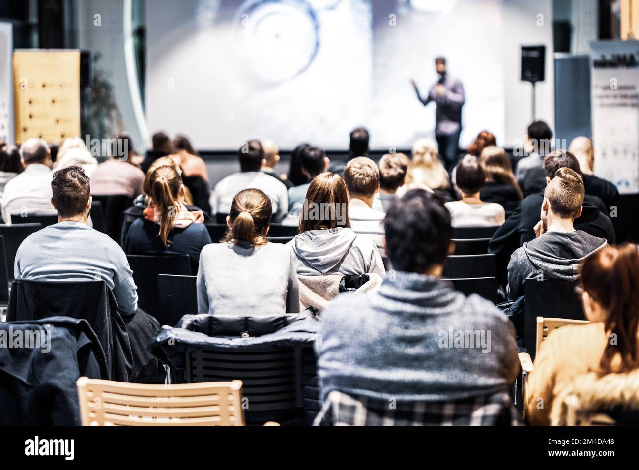 Speaker giving a talk in conference hall at business event. Audience at ...