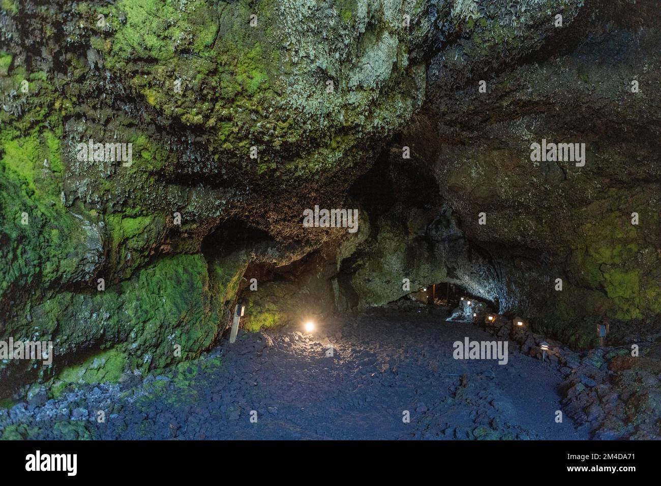 Exploring a volcanic cave in the Volcanic Caves Park at the foot of ...