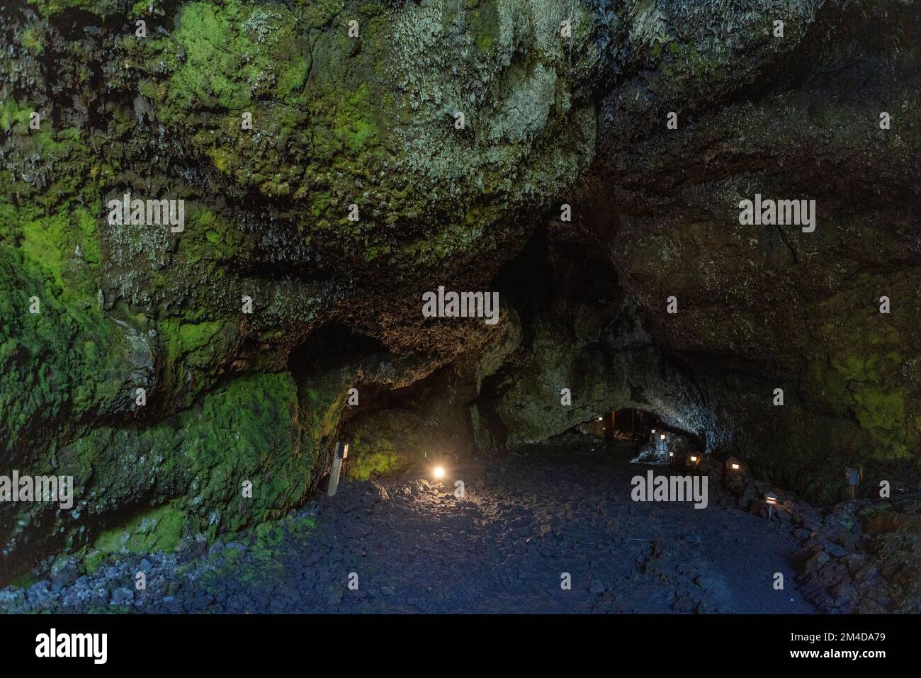 Exploring a volcanic cave in the Volcanic Caves Park at the foot of ...