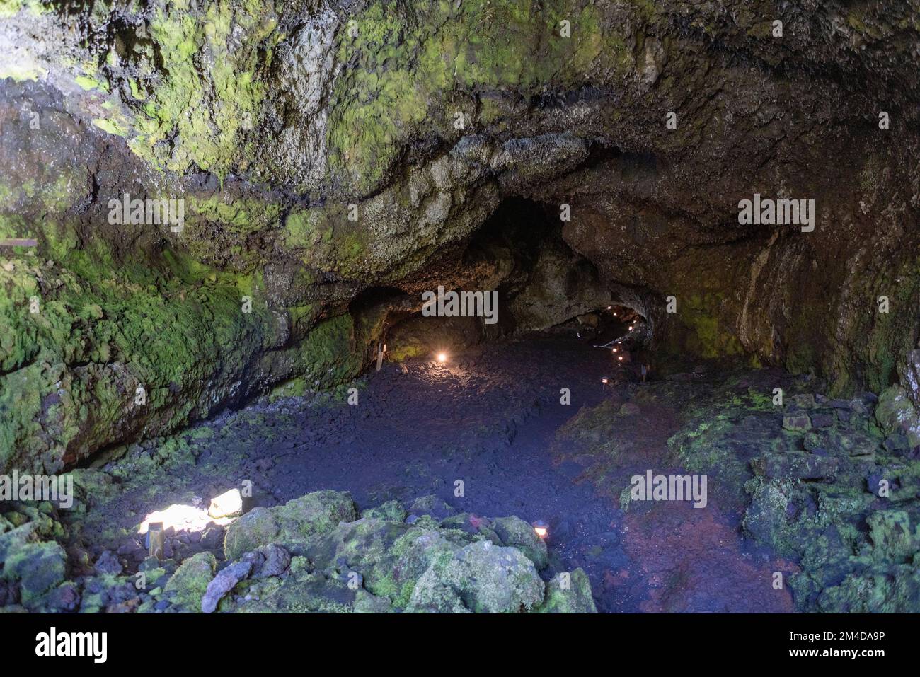 Exploring a volcanic cave in the Volcanic Caves Park at the foot of ...