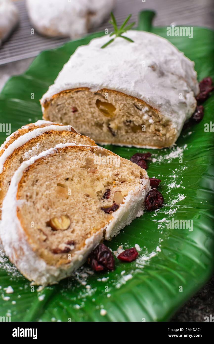 Christmas stollen with powdered sugar in a green plate Stock Photo - Alamy