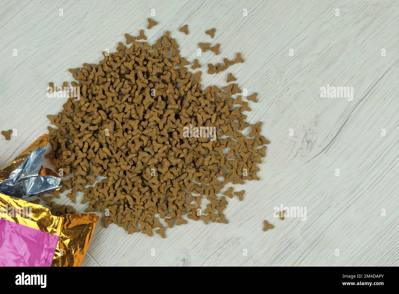 Dry fodder for cats and dogs in package on a wooden background. Top ...