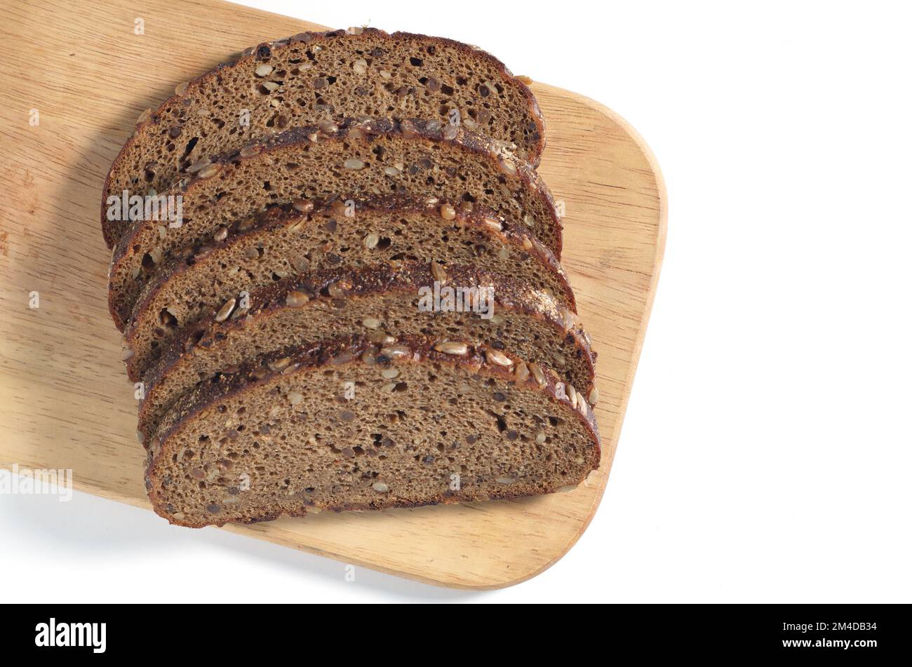 Slices of rye bread with seeds on cutting board on a white background ...