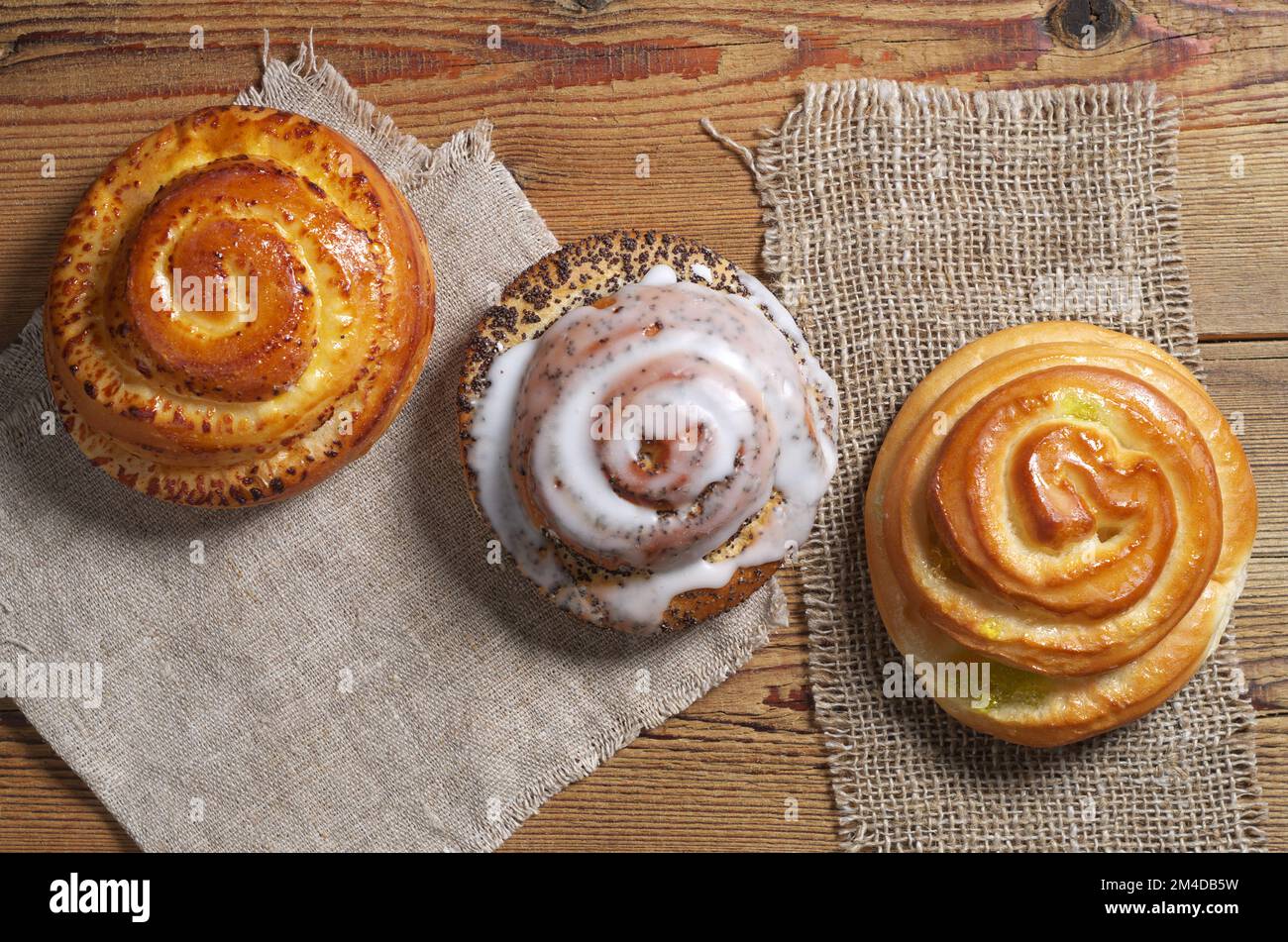 Various freshly baked pastries on rustic wooden table, top view Stock ...