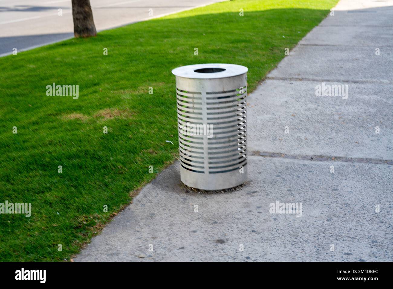 Metal dustbin on the sidewalk in the street Stock Photo - Alamy