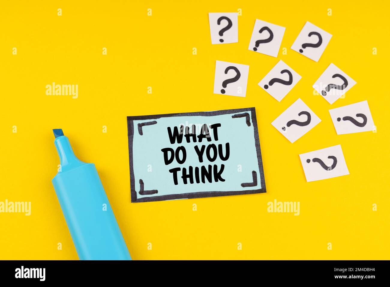 Education concept. On the yellow surface lies a blue marker, question ...