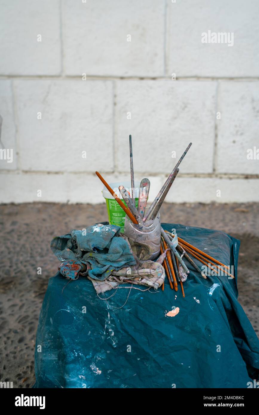 A bunch of creative paint brushes in a cut plastic bottle outside Stock ...