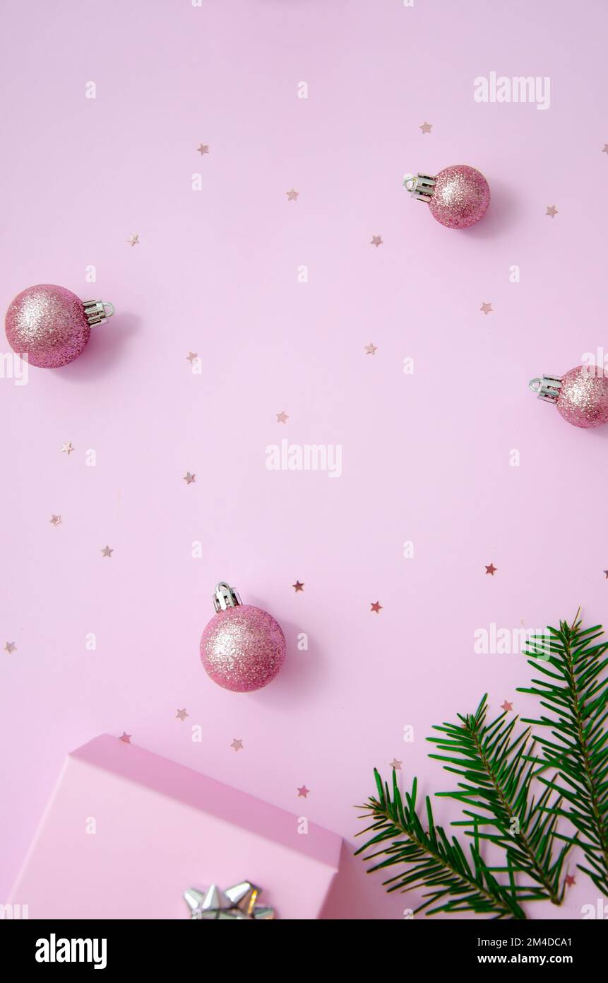 Christmas composition. Pink balls, wooden snowflakes,fir branches ...