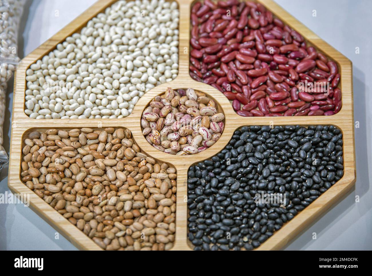 beans of various varieties in a wooden bowl closeup Stock Photo - Alamy