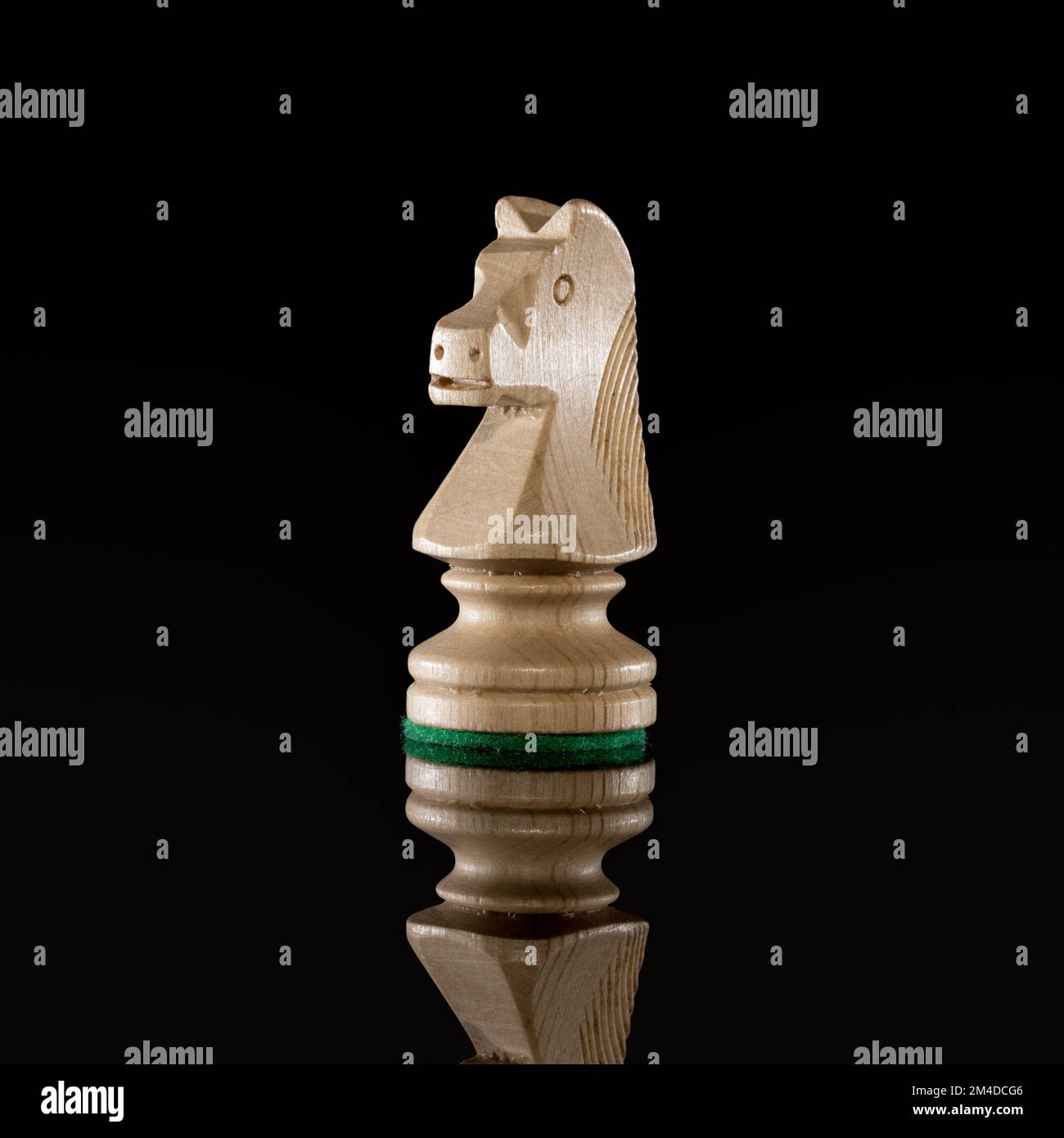 Wooden white chess knight isolated at dark background with transparent ...