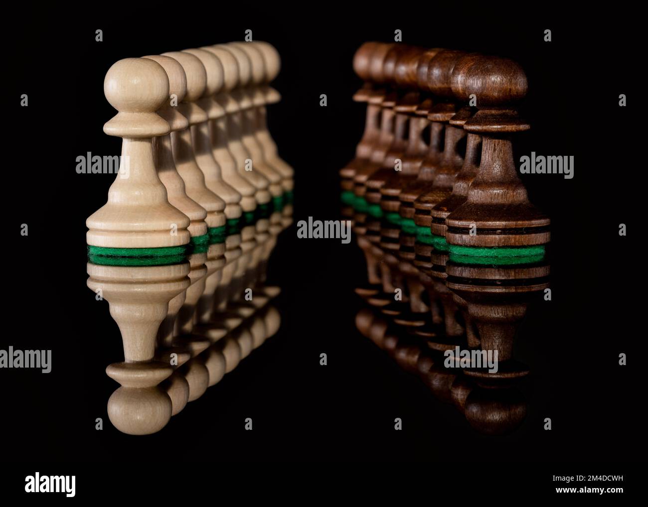 Two diagonal opposite lines of wooden chess pawns with selective focus ...