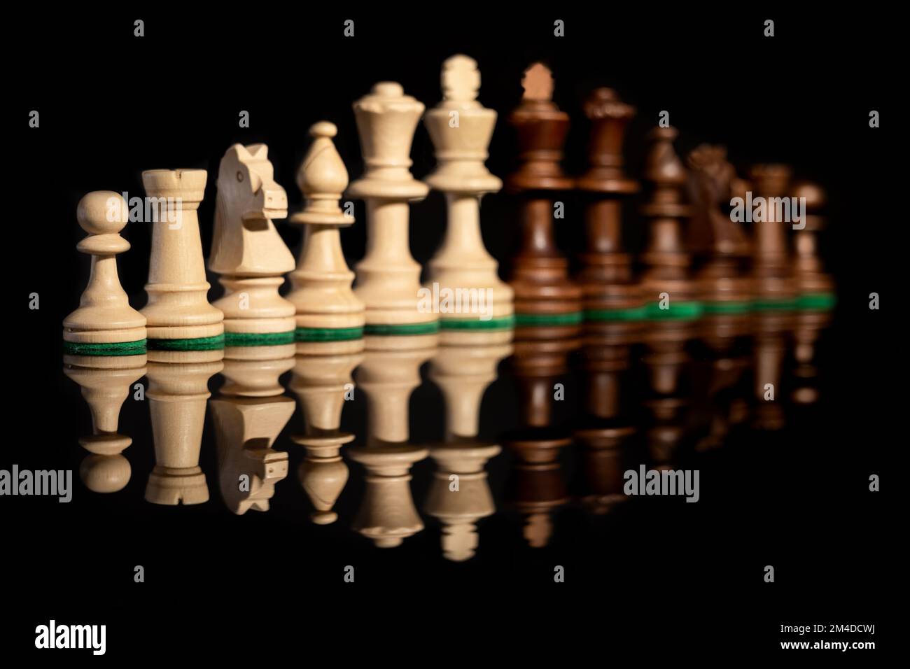 Diagonal line of wooden chess pieces with selective focus isolated at ...