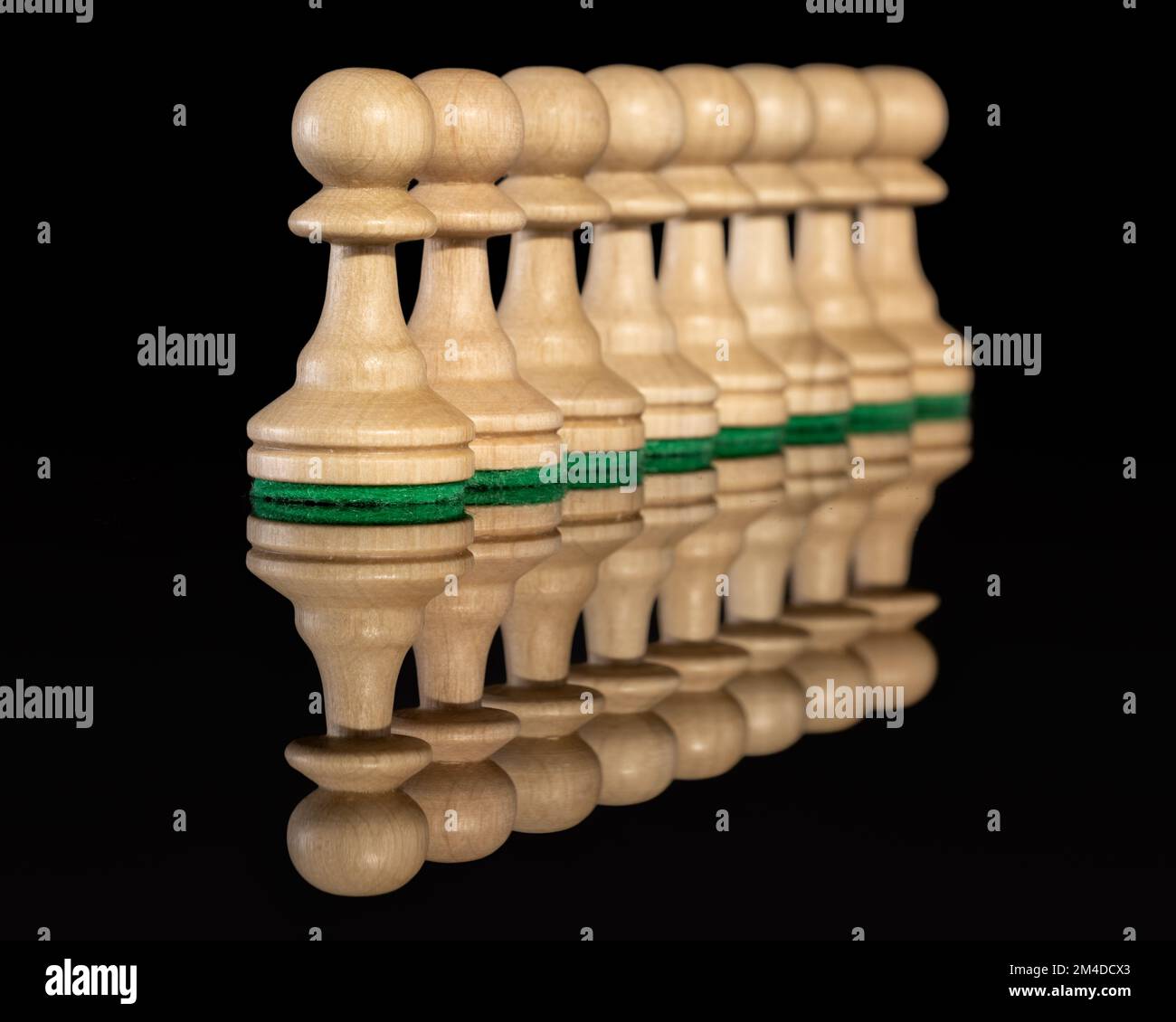 Diagonal line of white wooden chess pawns with selective focus isolated ...