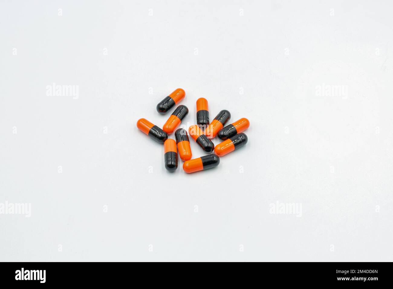 Medical capsules orange black closeup on wtite background Stock Photo ...