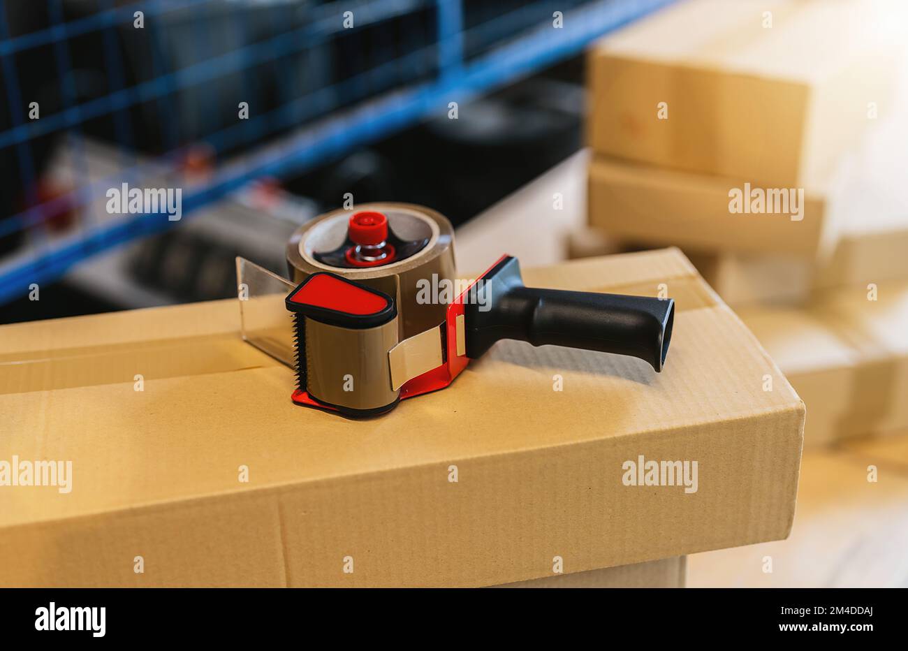 shipping boxes with tape dispenser and adhesive tape at warehouse of ...