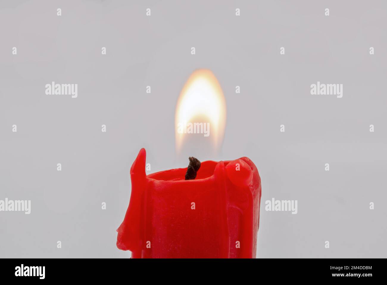 burning small red candle stub closeup on white background Stock Photo ...