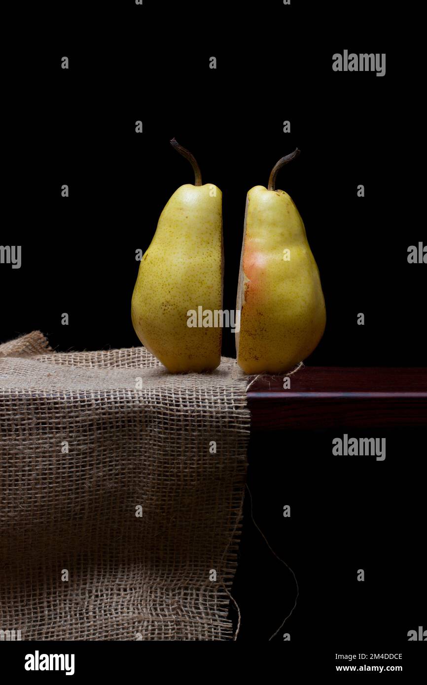 Two pieces of sliced ripe pears on a wooden shelf Stock Photo - Alamy