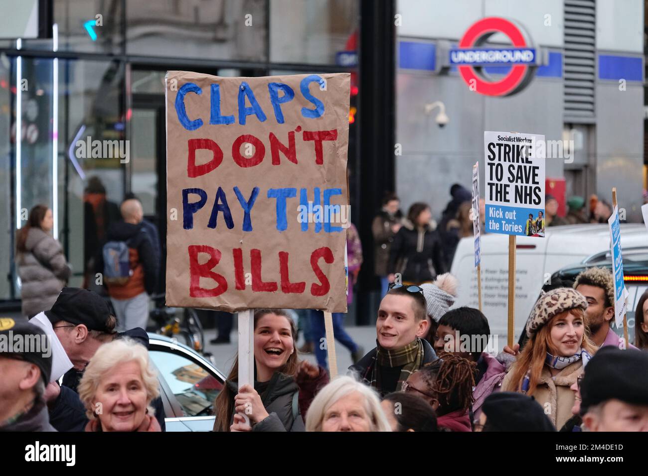 London, UK. 20th December, 2022. A healthcare worker carries a banner ...