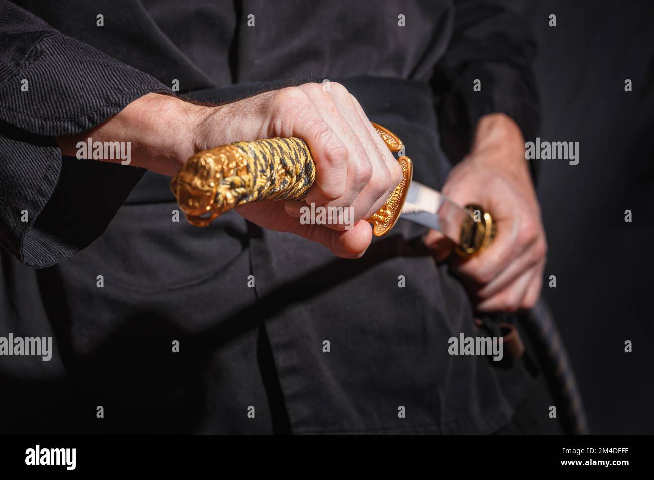 The samurai holding a Japanese katana sword. Photo of a warrior dressed ...